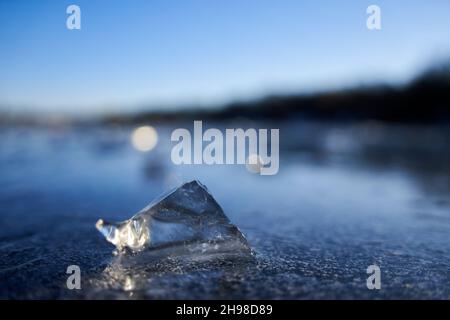 Ice splinters lies on a frozen lake. Depth of field, copy space. Deep ...