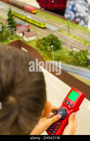 Boy child operating locomotive with Roco 10810 Z21 multiMAUS device at ...
