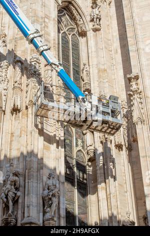 Milan Italy 1 December 2021: Technicians on lifting platform for scheduled maintenance plan and ...