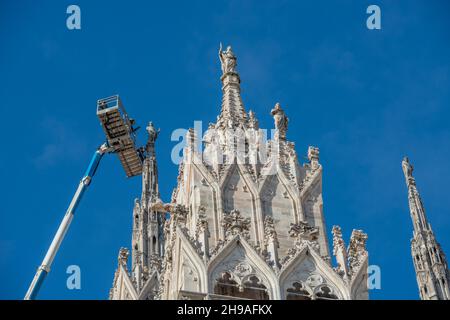 Milan Italy 1 December 2021: Technicians on lifting platform for scheduled maintenance plan and ...