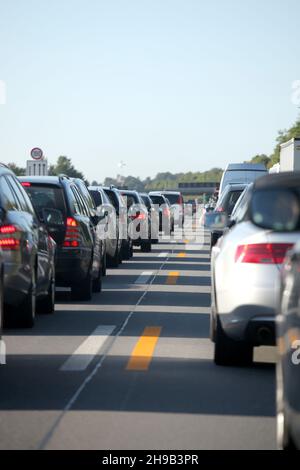 Traffic waiting at a busy junction and many vehicles rush under huge ...
