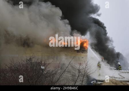 Firefighters work to extinguish a fire that broke out at a commercial ...