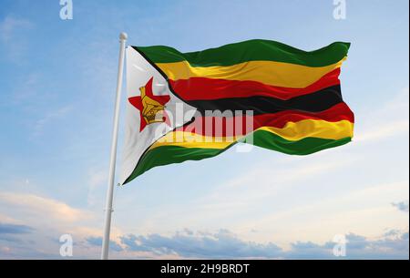 official flag of Saint Helena at cloudy sky background on sunset ...