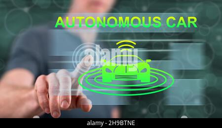 Man touching an autonomous car concept on a touch screen with his ...