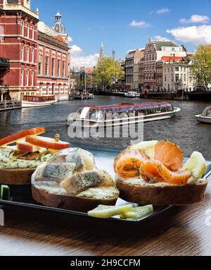 Amsterdam city with fishplate (salomon and codfish sandwiches) against ...