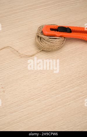 cutter and rough string on a wooden tabletop background Stock Photo - Alamy