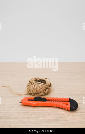 cutter and rough string on a wooden tabletop Stock Photo - Alamy