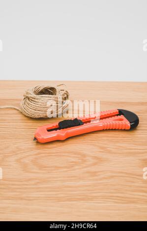 cutter and rough string on a wooden tabletop Stock Photo - Alamy