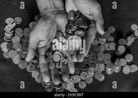 Grayscale shot of coins on male hands Stock Photo - Alamy