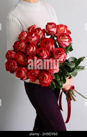 Bouquet of red roses. Gift idea for valentine's day. Florist woman ...
