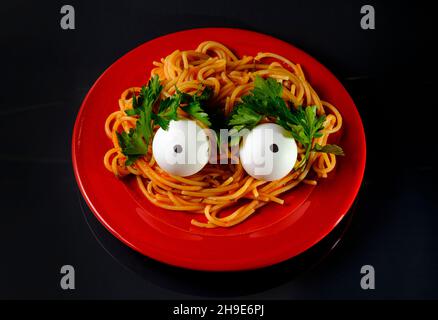 Spaghetti alien monster with eyeballs scared of being eaten Stock Photo ...