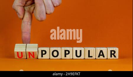 Popular or unpopular symbol. Businessman turns wooden cubes and changes ...