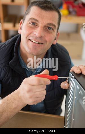 a man fitting a new oven in kitchen Stock Photo - Alamy