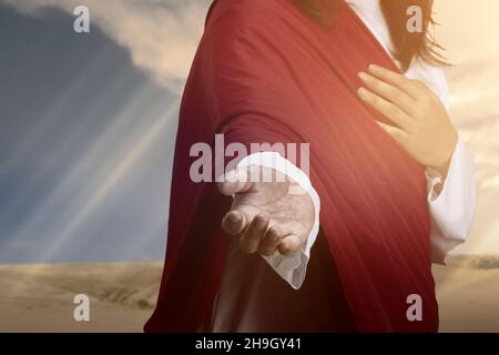 Jesus Christ giving a helping hand to human with a sunset sky ...