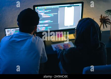 Mobile developers team writes program code on a computer, programmers ...