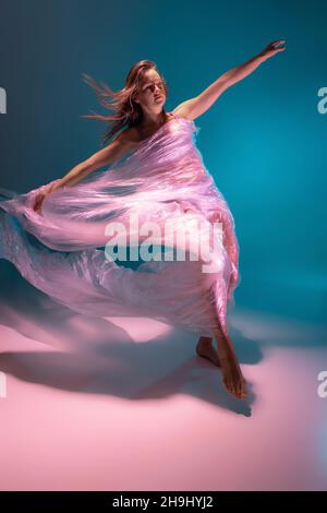 Stylish contemp dancer, beautiful woman dancing isolated on yellow ...