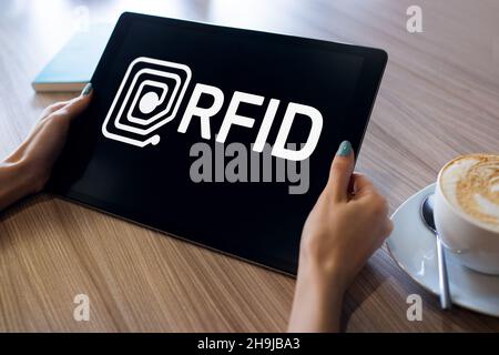 RFID Radio frequency identification technology concept on device screen ...