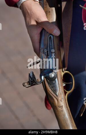 An historical reenactor holds a replica 19th century flintlock musket ...