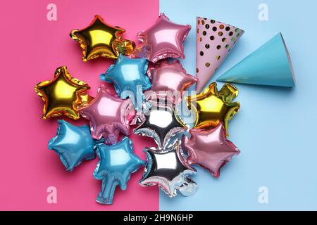 Beautiful different balloons and party hats on color background Stock ...