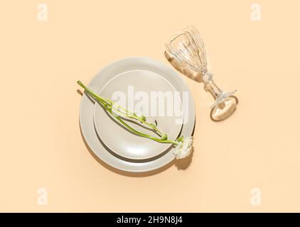 Simple table setting and ranunculus flower on color background Stock ...
