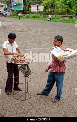 Two vendor talking each other at bus stand Stock Photo - Alamy