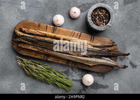 Fried river lamprey , on gray stone table background, top view flat lay ...