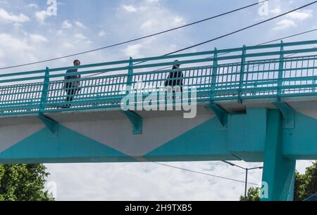 Two people walking in opposite directions at Dante's Square in Naples ...