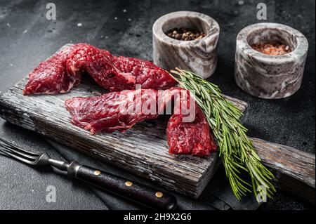 Flap steak flank raw cut and Machete skirt steak on wooden board. Black ...