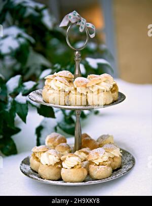 Small profiteroles on a cake stand Stock Photo - Alamy
