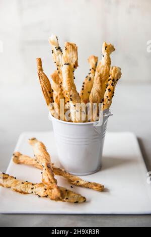 Savoury puff pastry straws in a mini bucket Stock Photo - Alamy