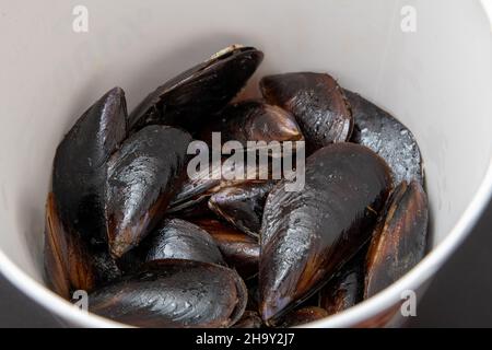 Fresh stuffed mussels in bucket on dark stone background Stock Photo ...