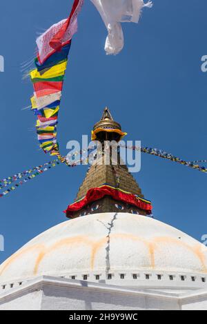 The dome, harmika and spire of the Boudhanath Stupa with prayer flags ...
