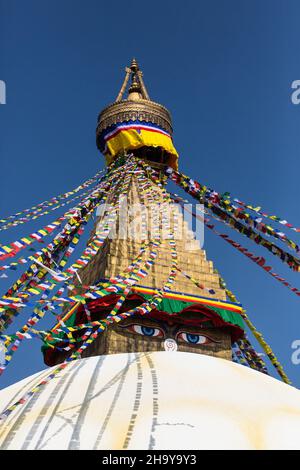 The dome, harmika and spire of the Boudhanath Stupa with prayer flags ...