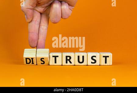Distrust or trust symbol. Businessman turns wooden cubes, changes words ...