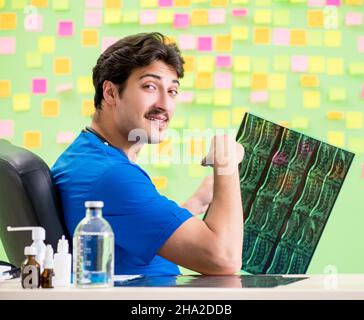 Young doctor with many reminders and urgent work Stock Photo - Alamy