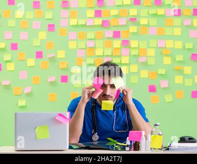 Young doctor with many reminders and urgent work Stock Photo - Alamy