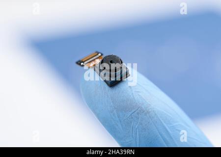 Smartphone camera module on a fingertip Stock Photo - Alamy