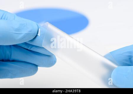 Flexible semitransparent plastic like material in scientist hands ...
