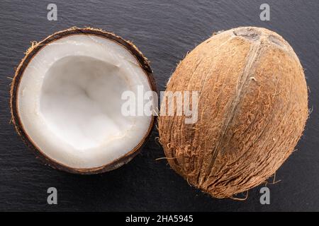 One natural coconut on a slate board, close-up, top view Stock Photo ...