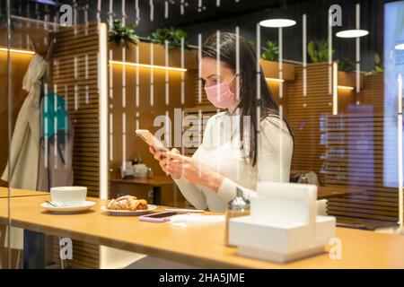A person types on a cellphone in Ottawa on, Dec. 15, 2025. THE CANADIAN ...