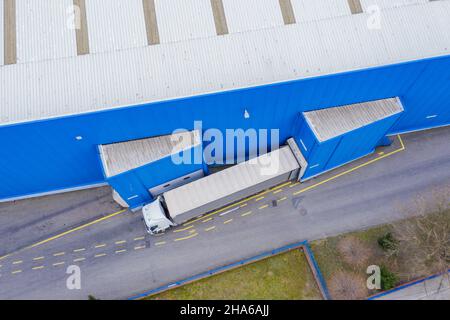 Aerial Shot of Industrial Loading Area where Many Trucks Are Unloading ...