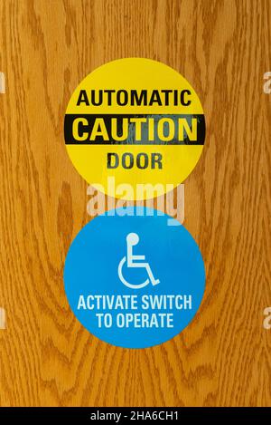 Yellow warning sign "Caution: Wheelchair Traffic Ahead" with pictogram ...