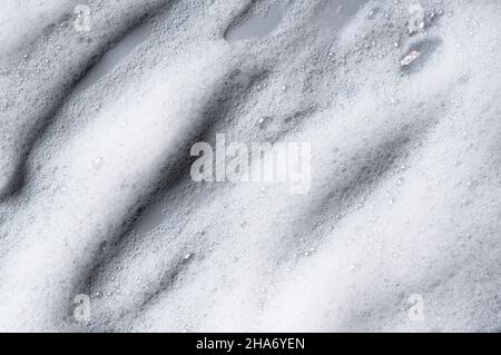 Bubbles texture background on gray background. Soap, shampoo, mousse ...