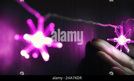 Colorful bright electric impression on a blue flower against a black ...