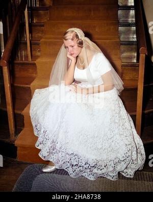 1950s JILTED SAD UNHAPPY BLOND BRIDE WEARING WEDDING DRESS SITTING ON ...