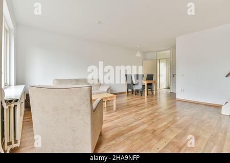 Comfortable sofa with cushions placed against light wall with TV and ...