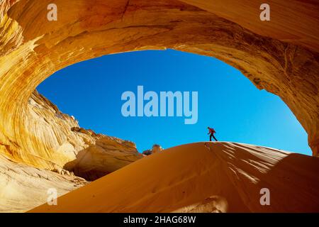 Hiker in the Great Chamber grotto, Utah, USA. Travel and journey scene ...