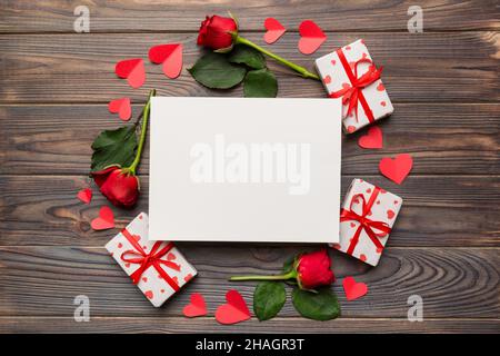 Frame made of rose, git box, heart and blank greeting card mockup on ...