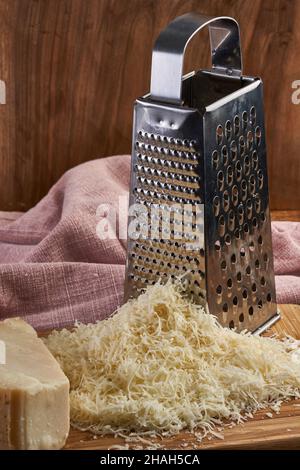 Portion of parmesan grated from a large block of parmigiano reggiano ...