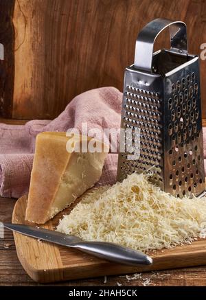 Portion of parmesan grated from a large block of parmigiano reggiano ...